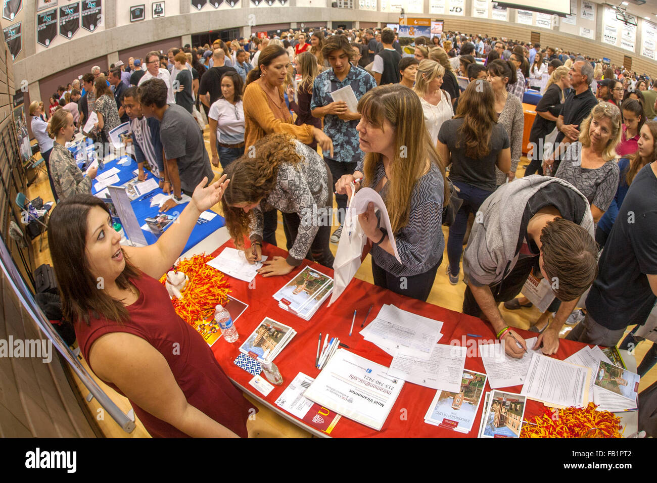 Multiracial high school students attend a college fair in an Aliso ...