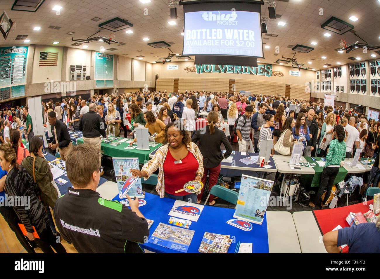 Multiracial high school students attend a college fair in an Aliso ...