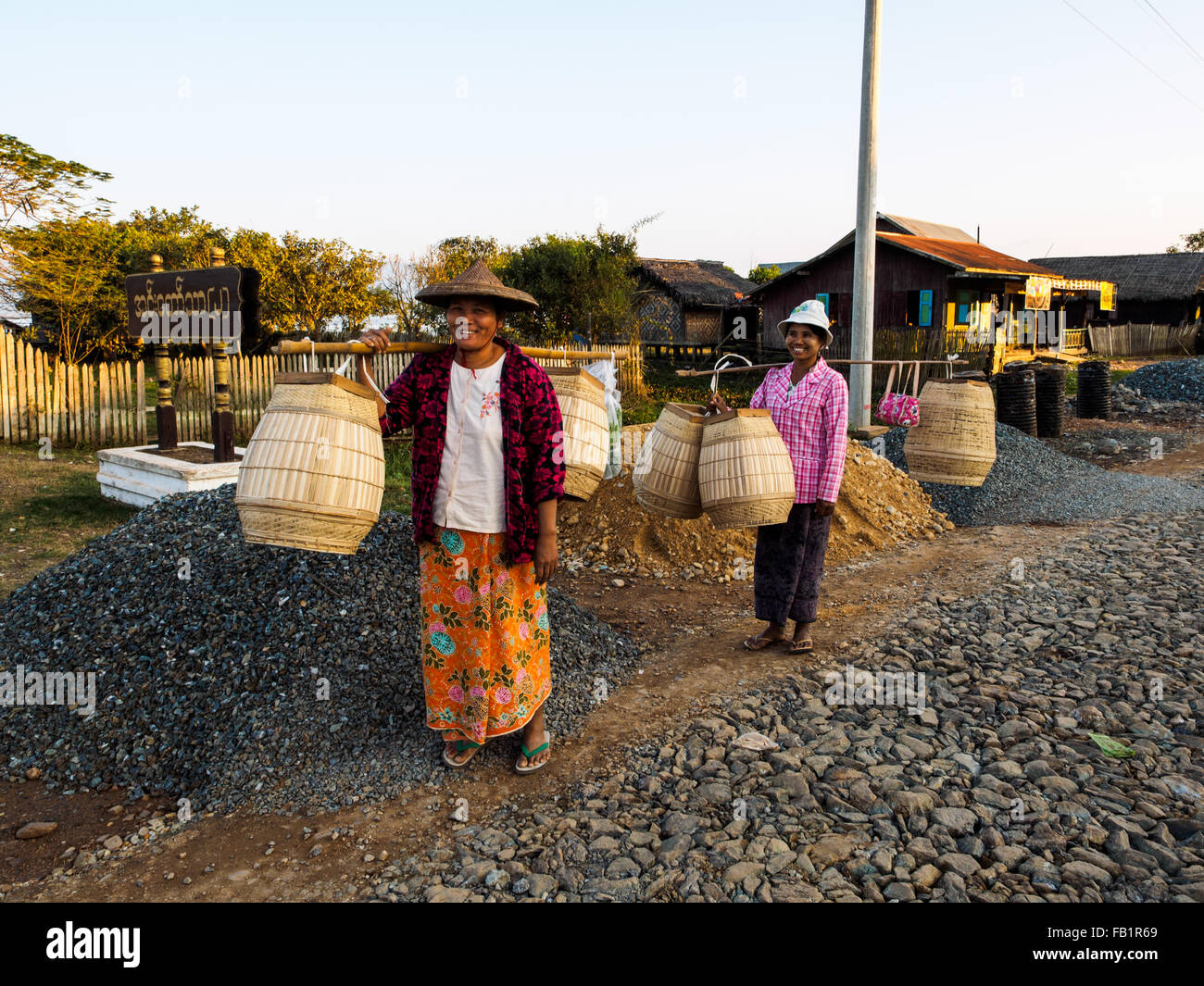 Two local women carrying some kind of bamboo work Stock Photo - Alamy