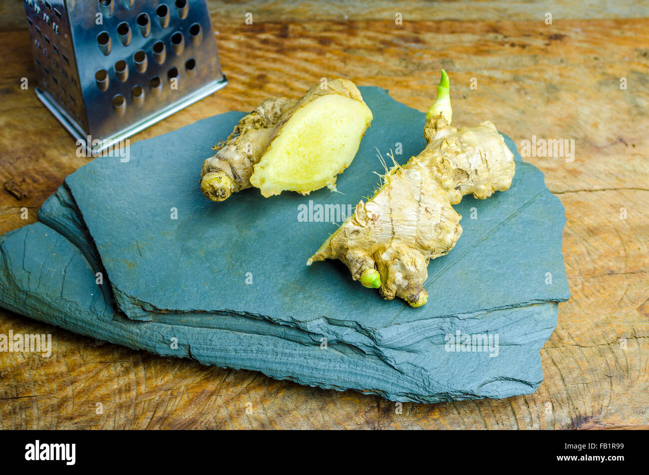 Ginger root on a stone background Stock Photo - Alamy