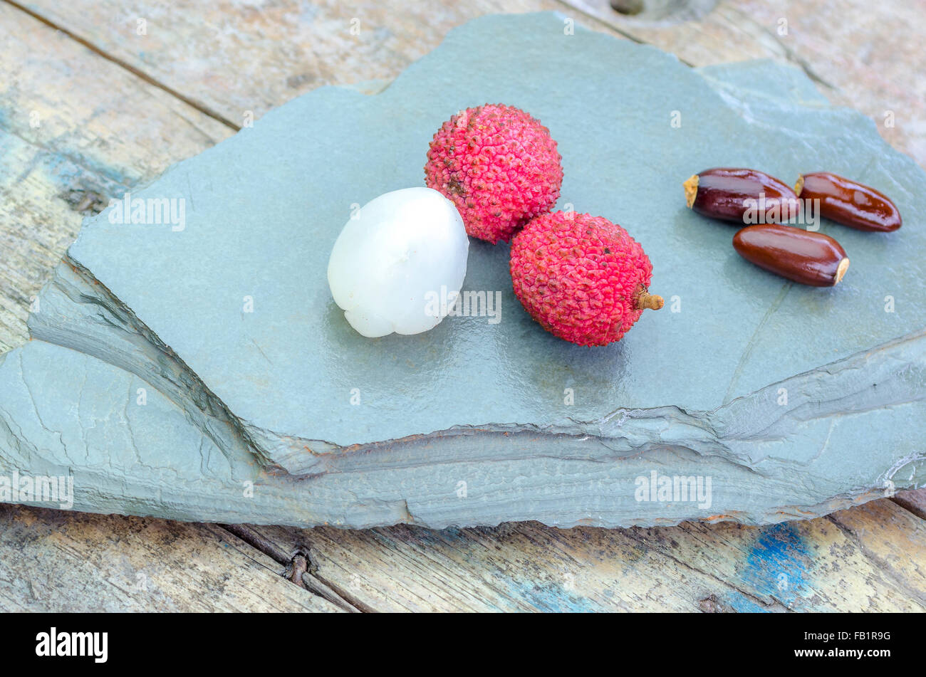 Lychee fruitsand pits on a stone beckground Stock Photo - Alamy