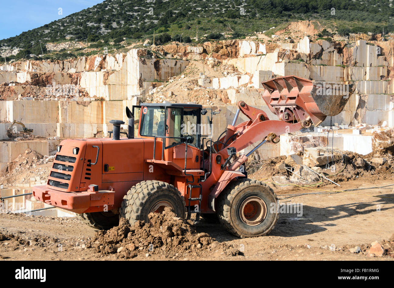 Industrial marble quarry, with cut blocks and workers and machines ...