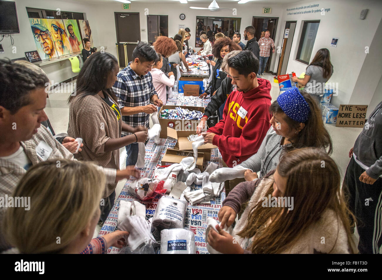 Multiracial young adult volunteers assemble hygiene kits for the ...