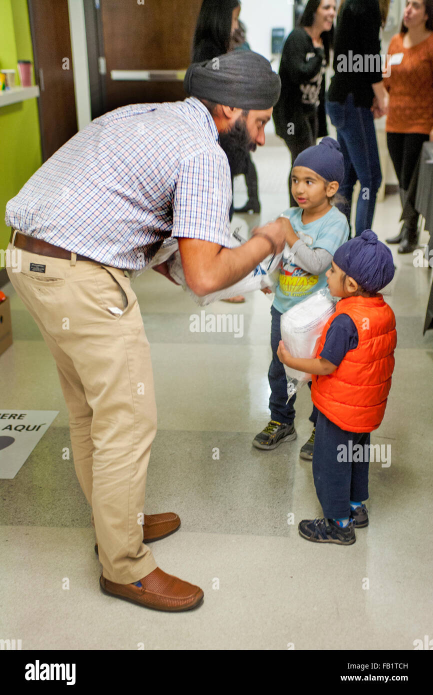 A Sikh father talks with his two sons in Costa Mesa, CA. Note turbans ...