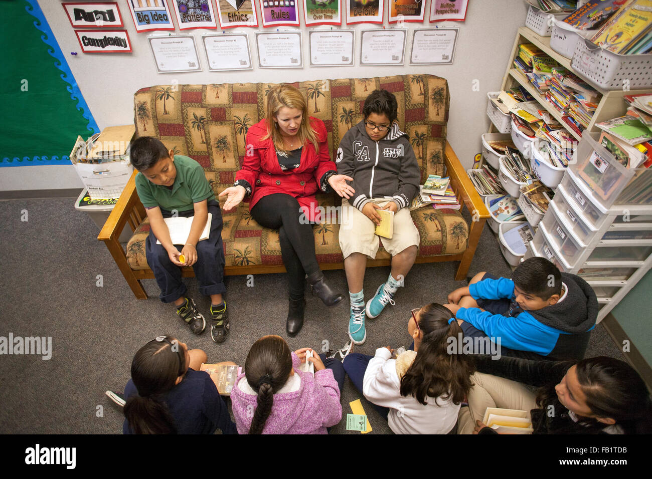 An elementary school teacher holds a reading seminar for her Hispanic ...