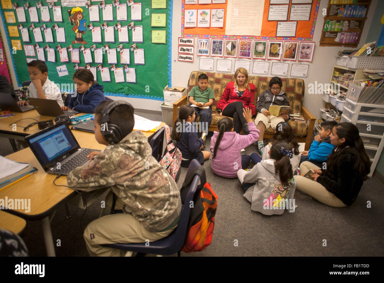 An elementary school teacher holds a reading seminar for her Hispanic ...