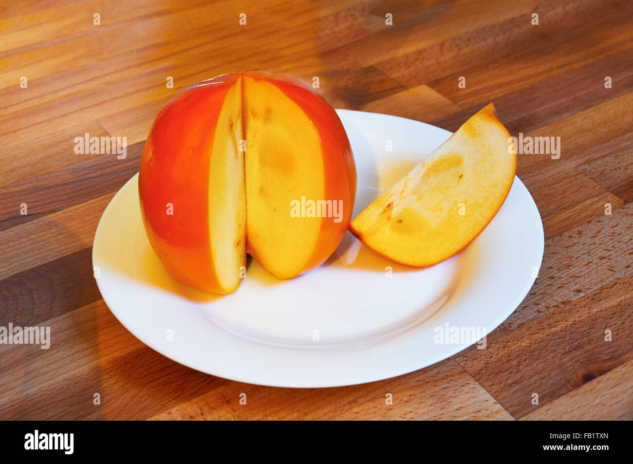 Asian juicy orange persimmon closeup Stock Photo - Alamy