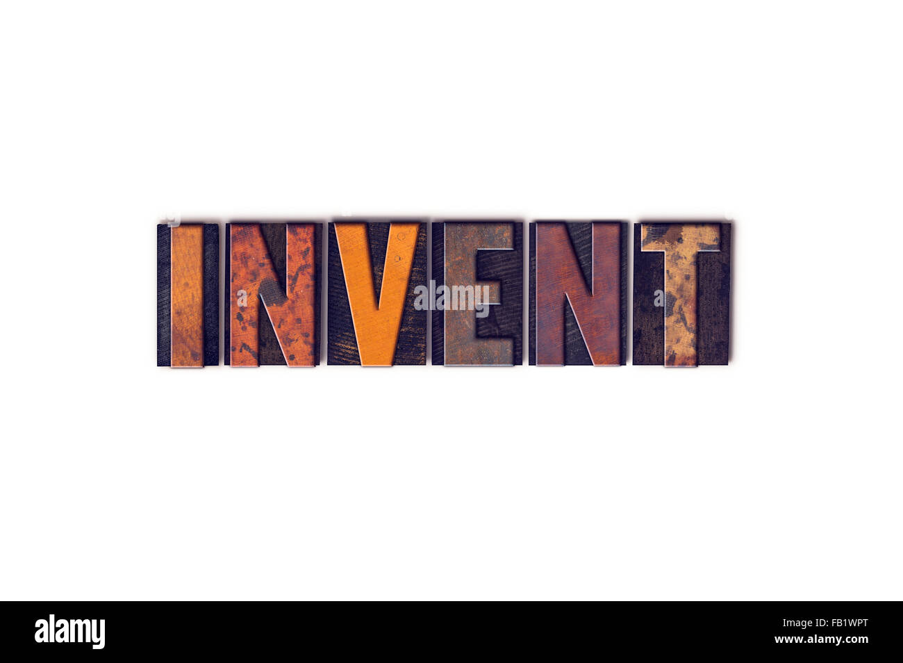 The word "Invent" written in isolated vintage wooden letterpress type ...