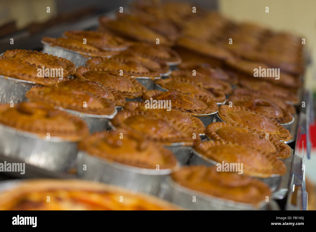 Rows of pork pies on display in a butchers shop ready to be sold Stock ...