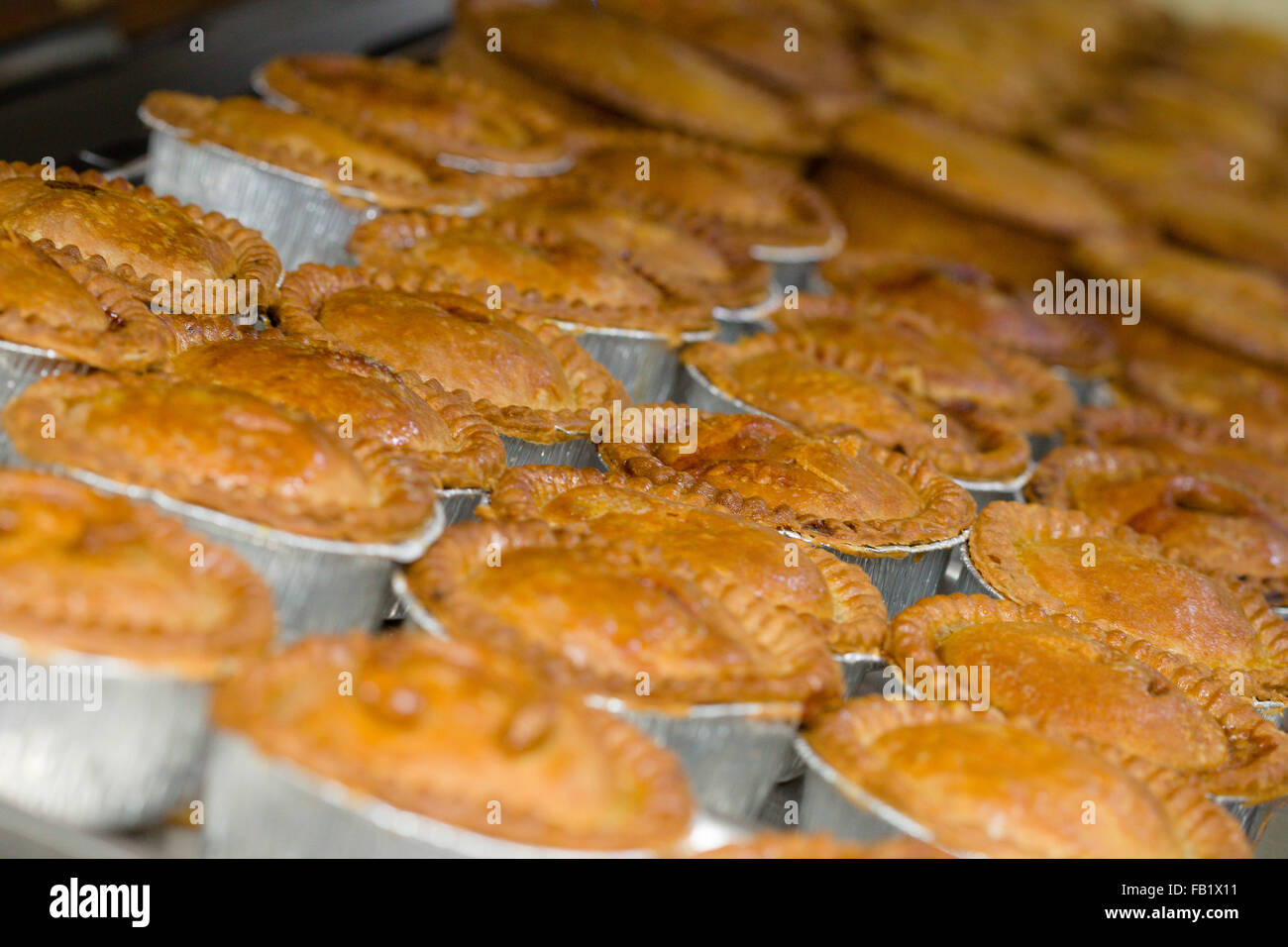 Rows of pork pies on display in a butchers shop ready to be sold Stock ...