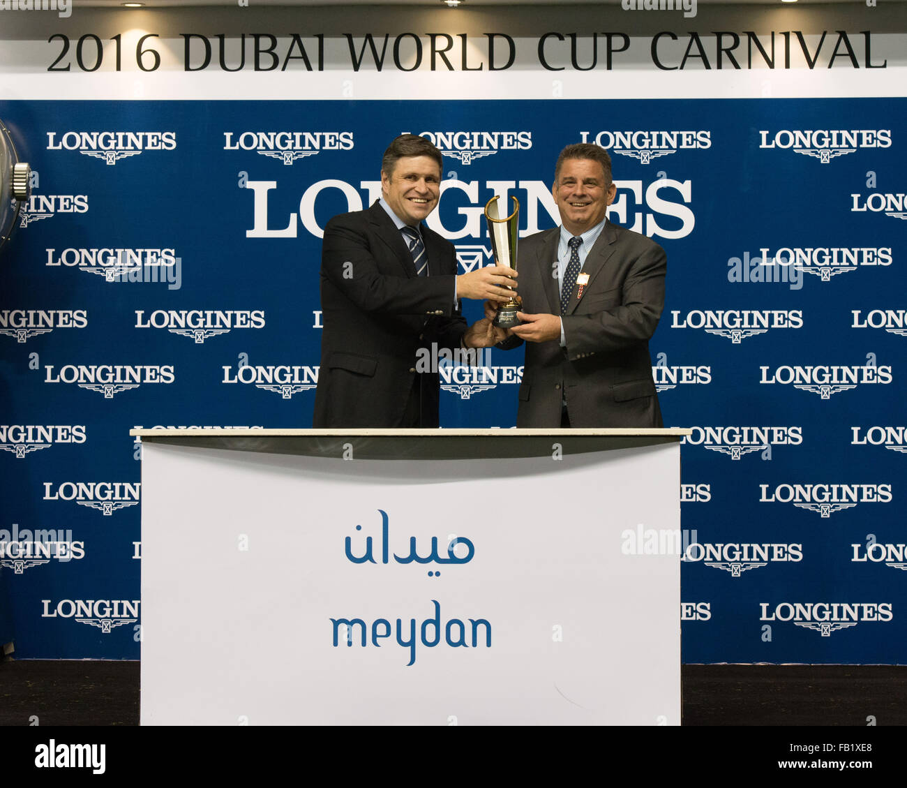 Dubai, UAE. 07th Jan, 2016. Trainer Doug Watson recieves the trophy ...