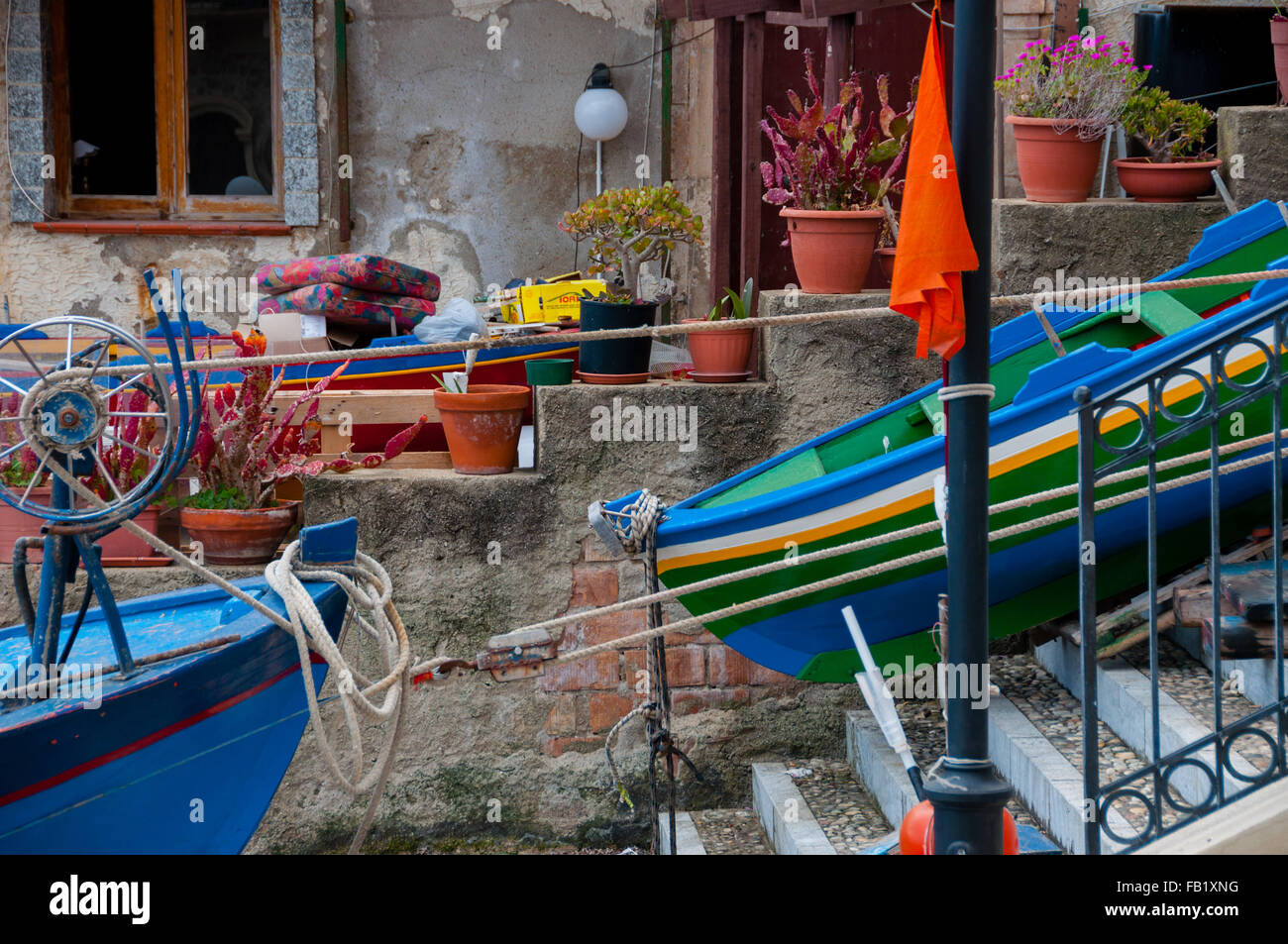 Two blue and green boats sitting on land in small italian town Scilla ...