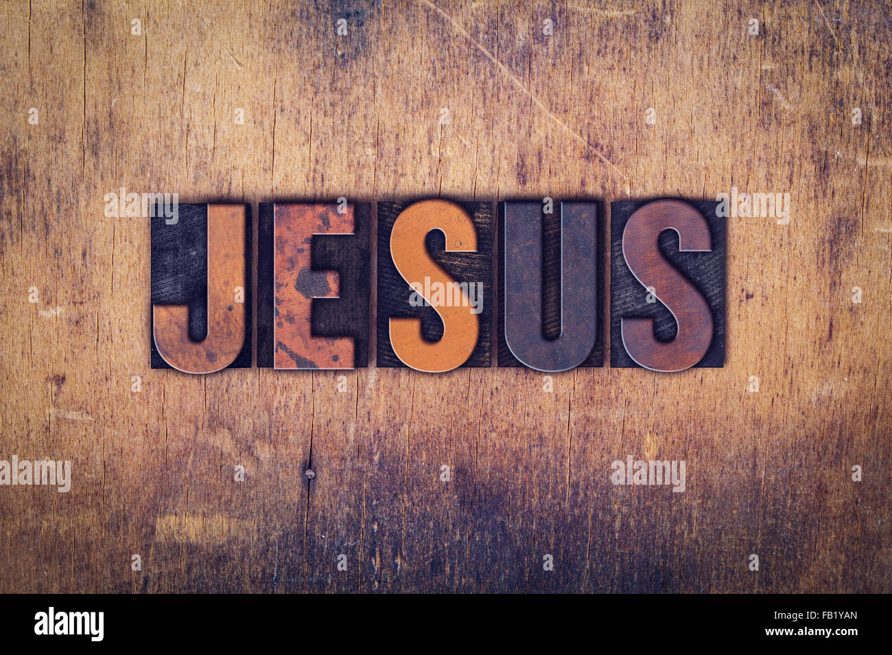 The word "Jesus" written in dirty vintage letterpress type on a aged ...