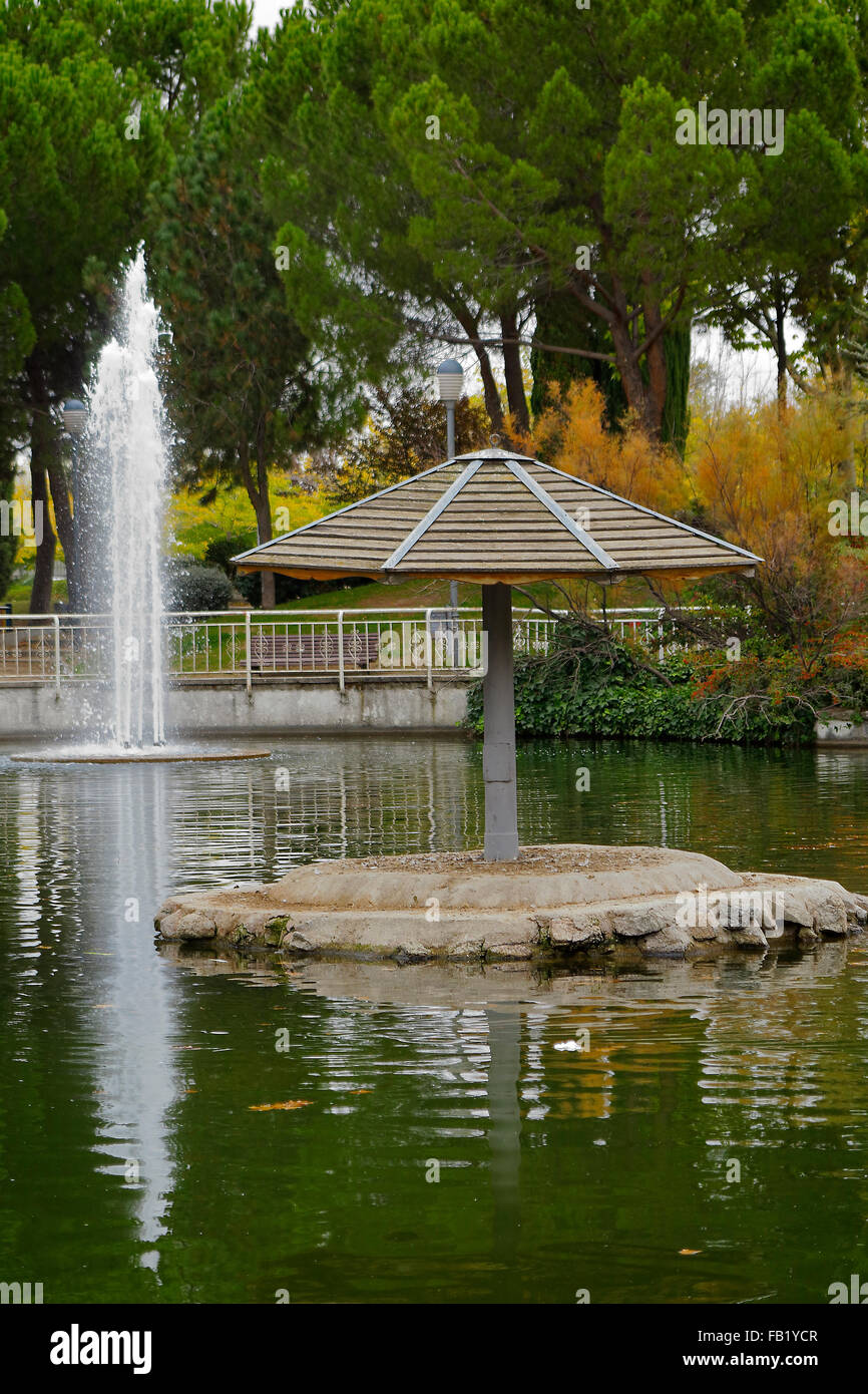 umbrella and fountain in the pond of a recreational area in the city of ...