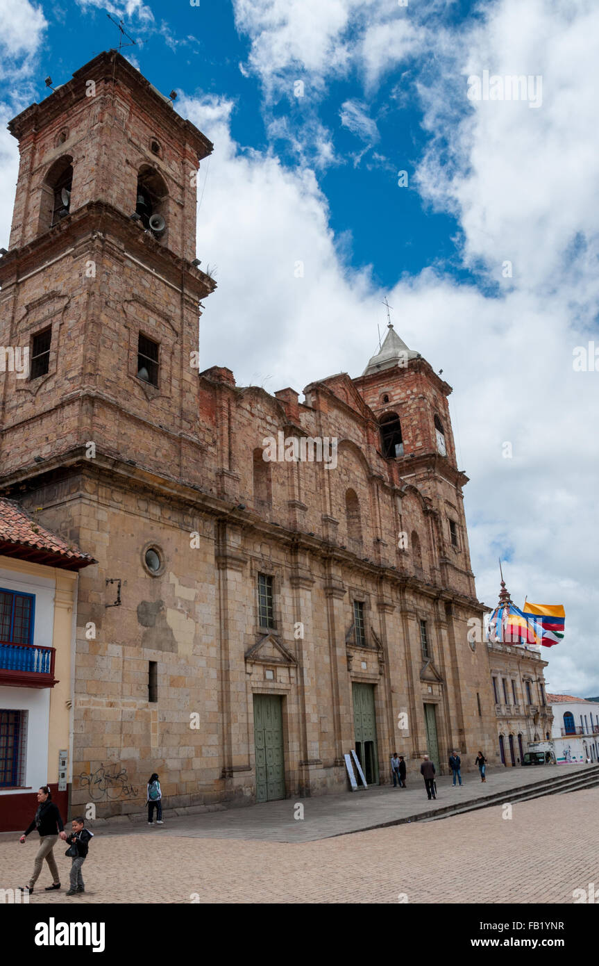 Old colonial beige stone church under blue sky with clouds Stock Photo ...