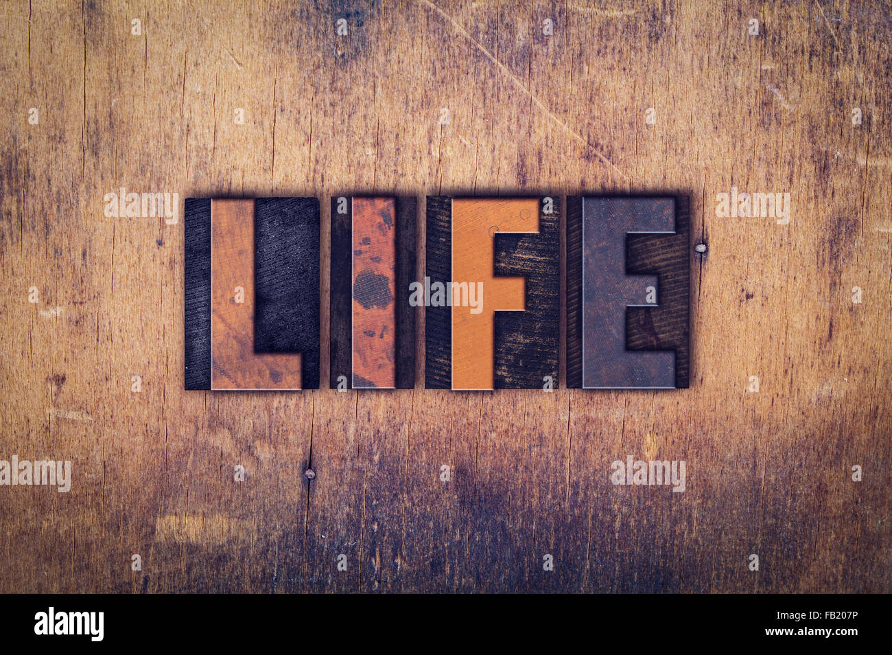 The word "Life" written in dirty vintage letterpress type on a aged ...