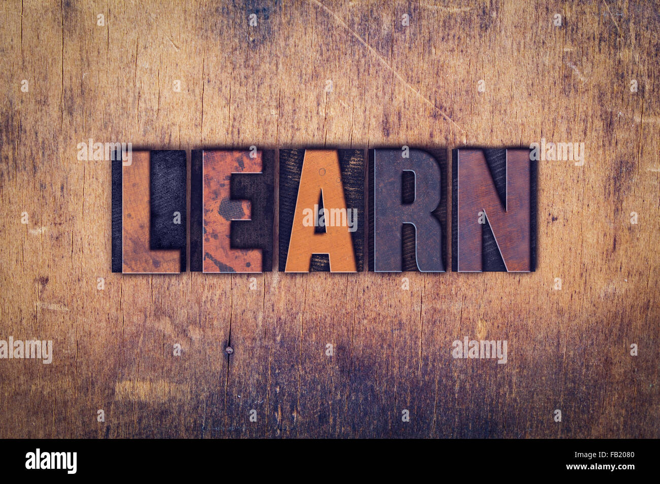 The word "Learn" written in dirty vintage letterpress type on a aged ...