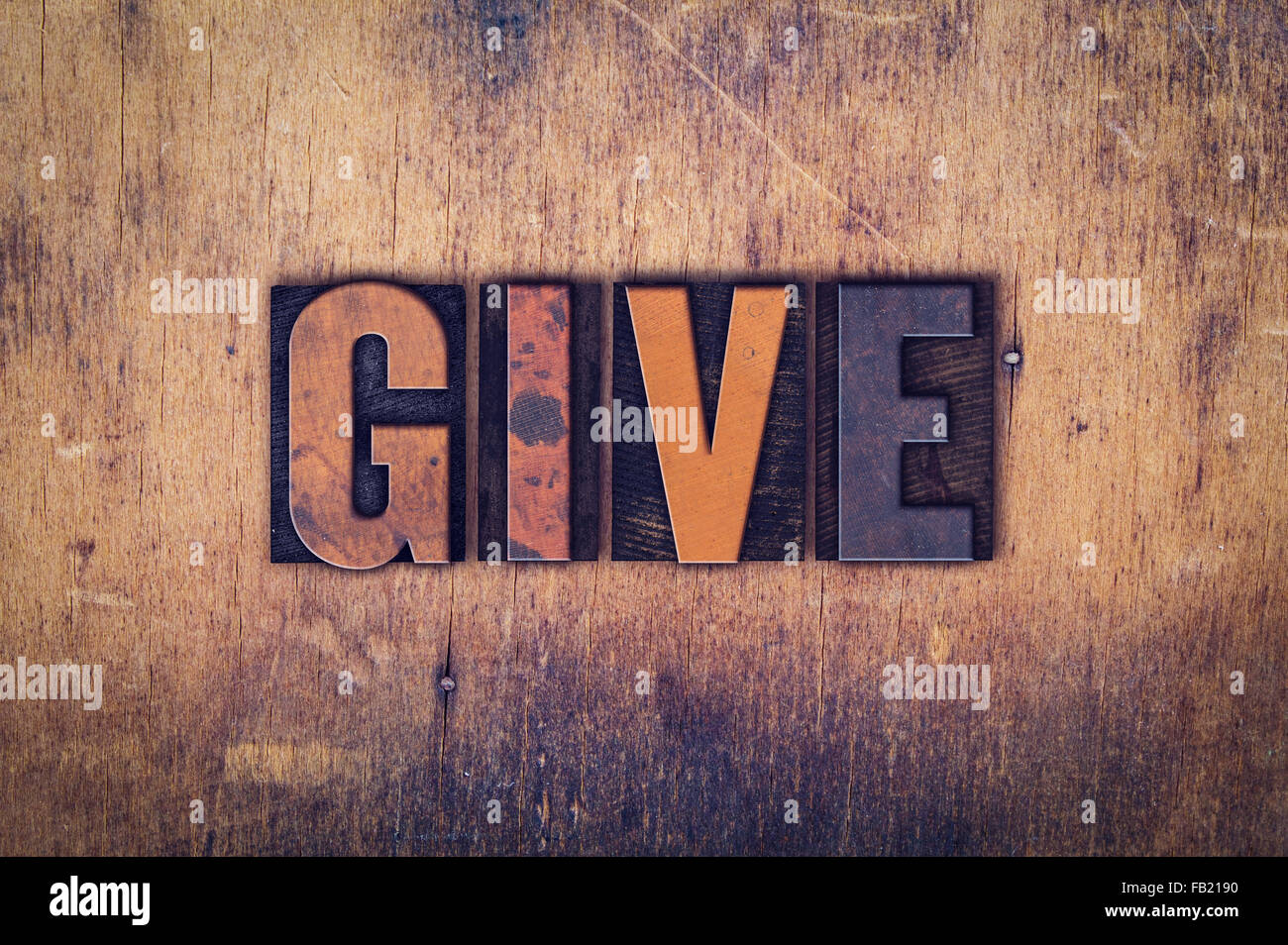 The word "Give" written in dirty vintage letterpress type on a aged ...