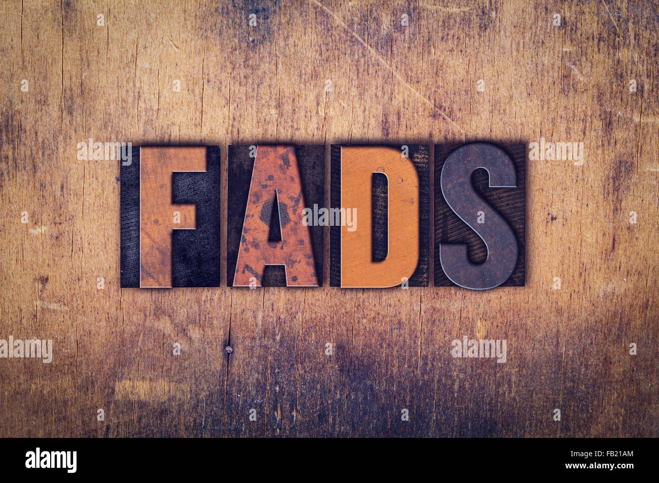 The word "Fads" written in dirty vintage letterpress type on a aged ...