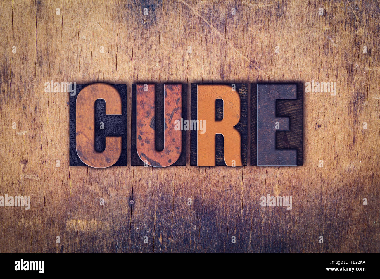 The word "Cure" written in dirty vintage letterpress type on a aged ...