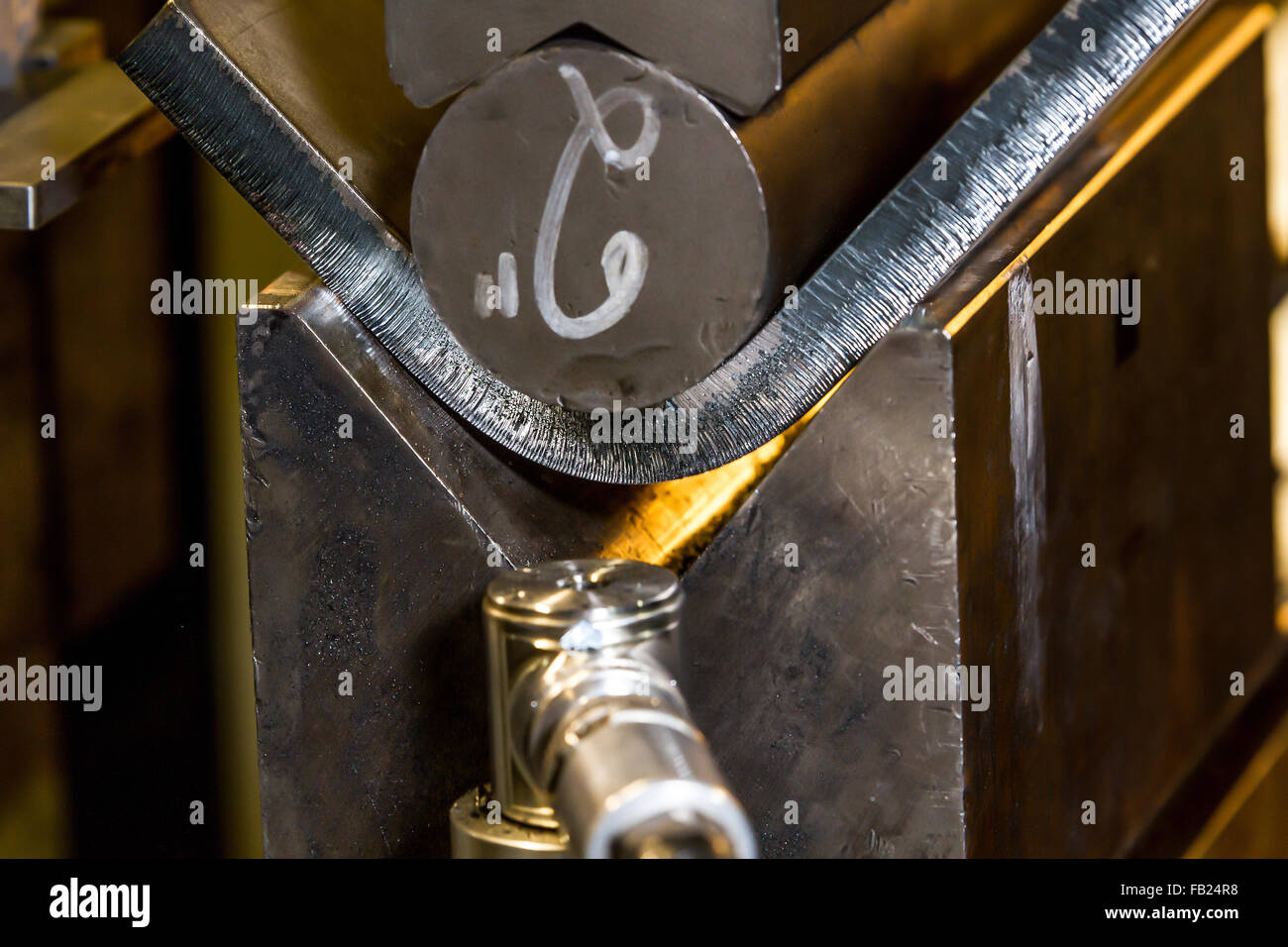 Half inch steel being bent in ninety degree press with vibration sensor ...