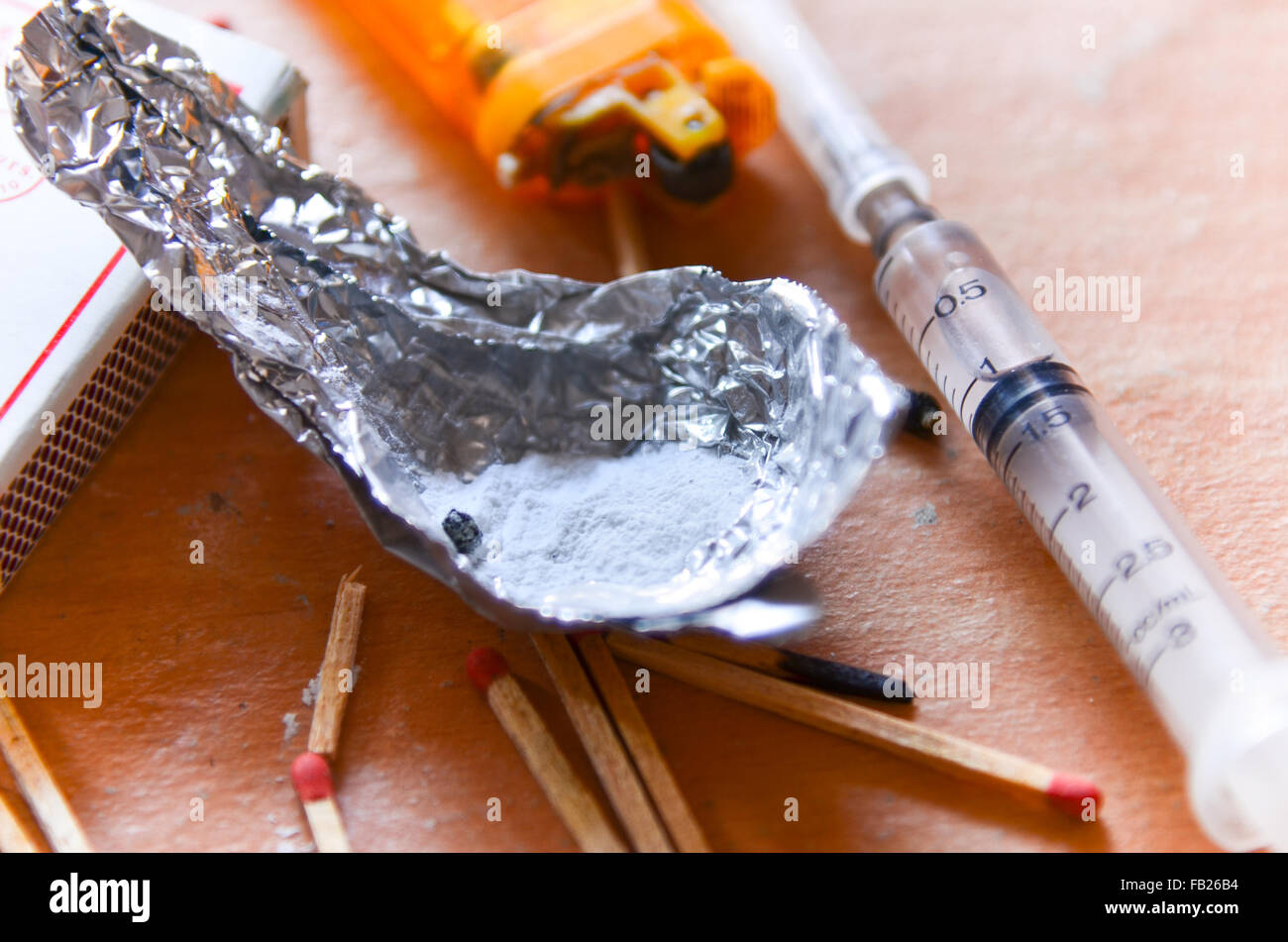 Drug syringe and cooked heroin on spoon Stock Photo - Alamy