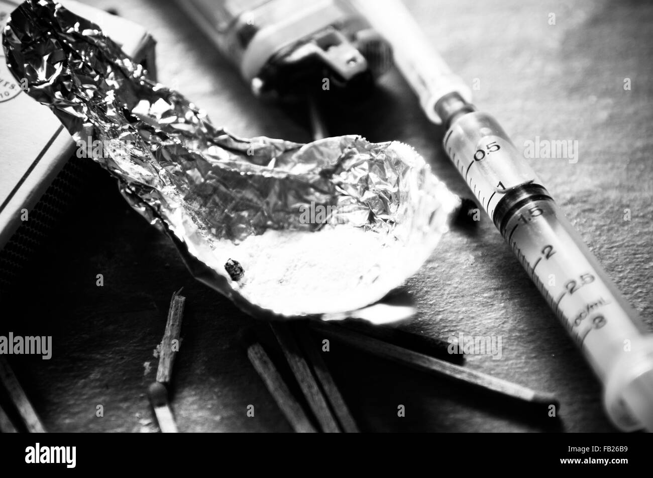 Drug syringe and cooked heroin on spoon Stock Photo - Alamy