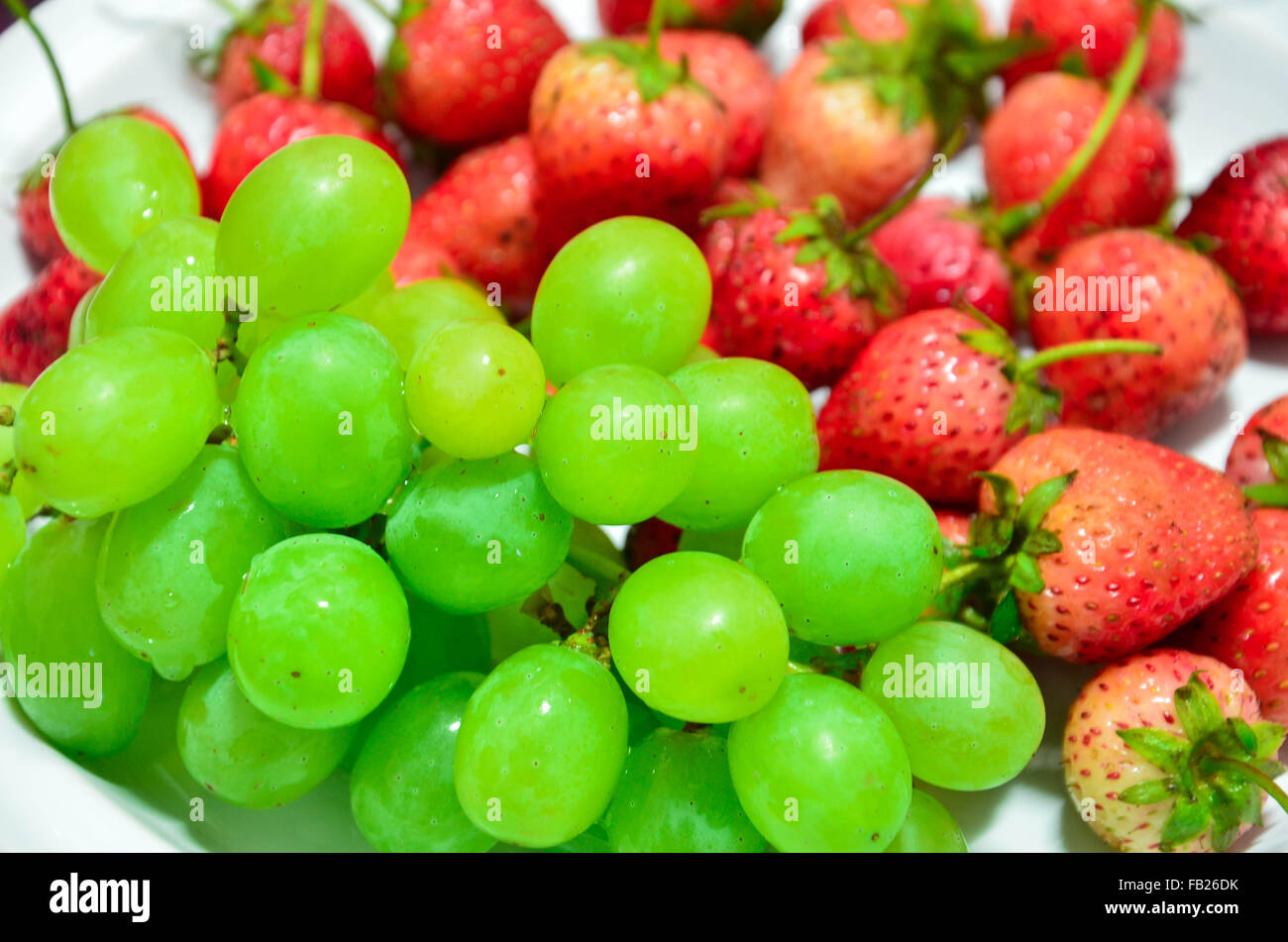 Fresh strawberries and grapes Stock Photo - Alamy