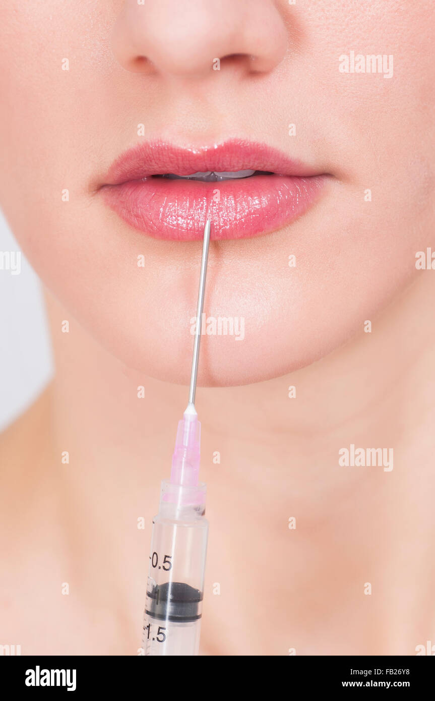 Close up of a young woman receiving a botox injection to her lips Stock ...