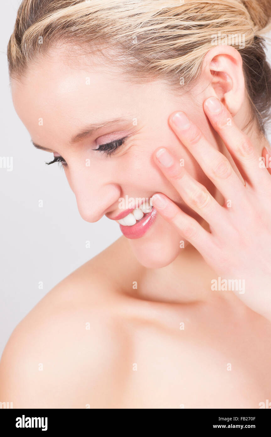 Happy young woman hand touching face Stock Photo - Alamy