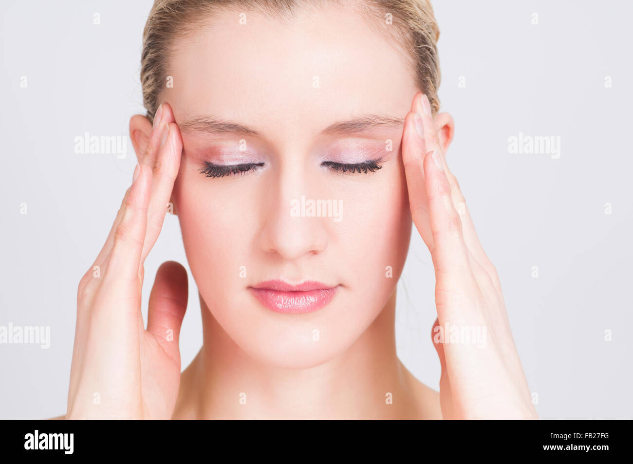 Close up woman rubbing temples hi-res stock photography and images - Alamy