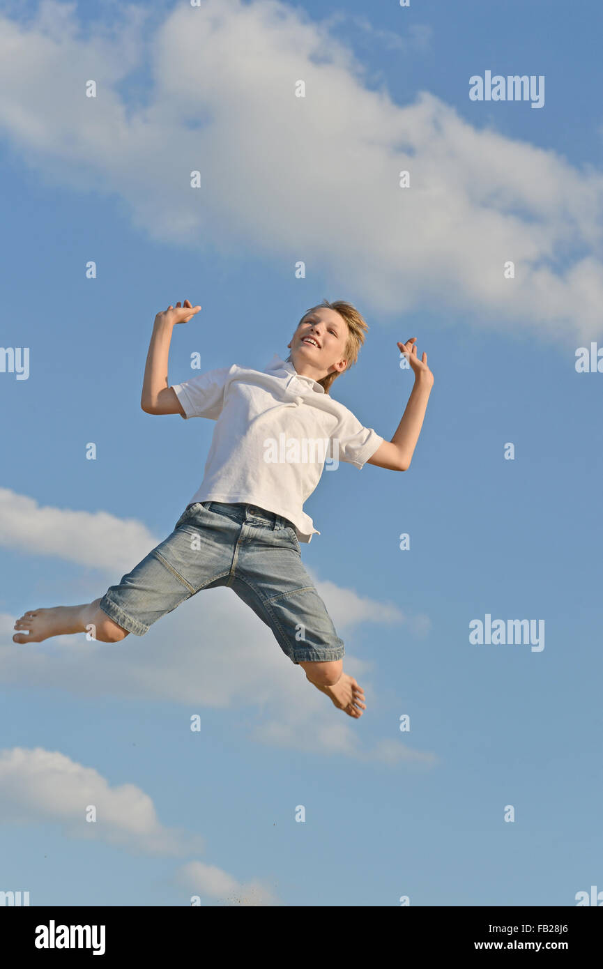 Boy on blue sky background Stock Photo - Alamy