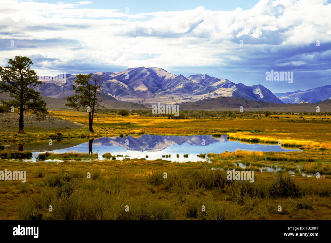 Autumn landscape of lake in the steppe prairie and mountains in the ...