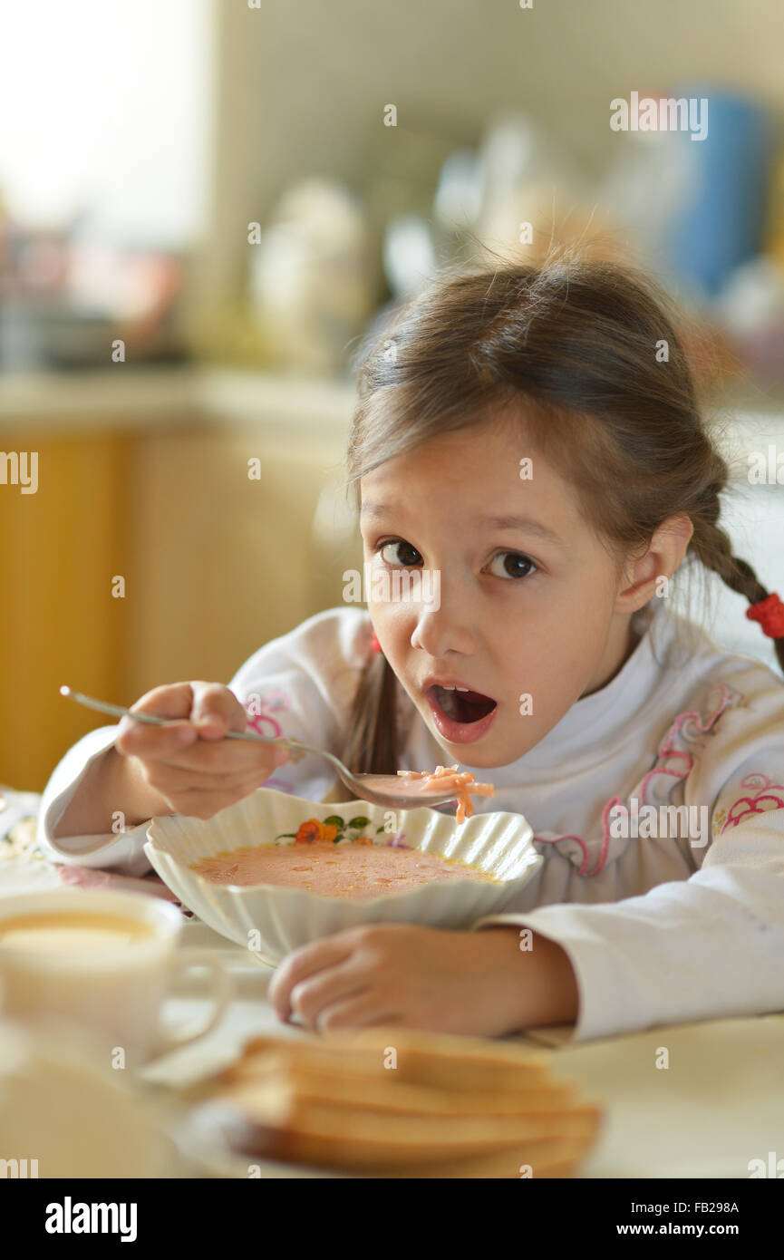 Little girl eating soup Stock Photo - Alamy