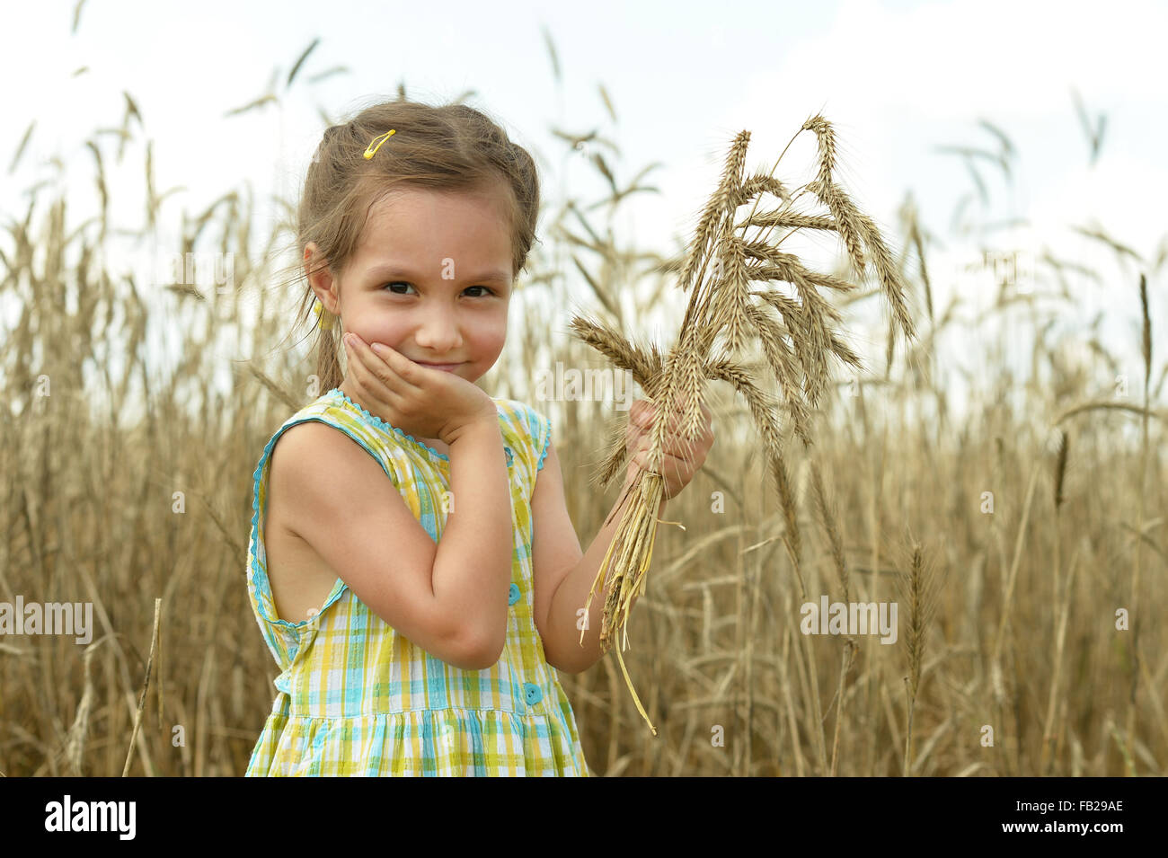Cute girl in field Stock Photo - Alamy