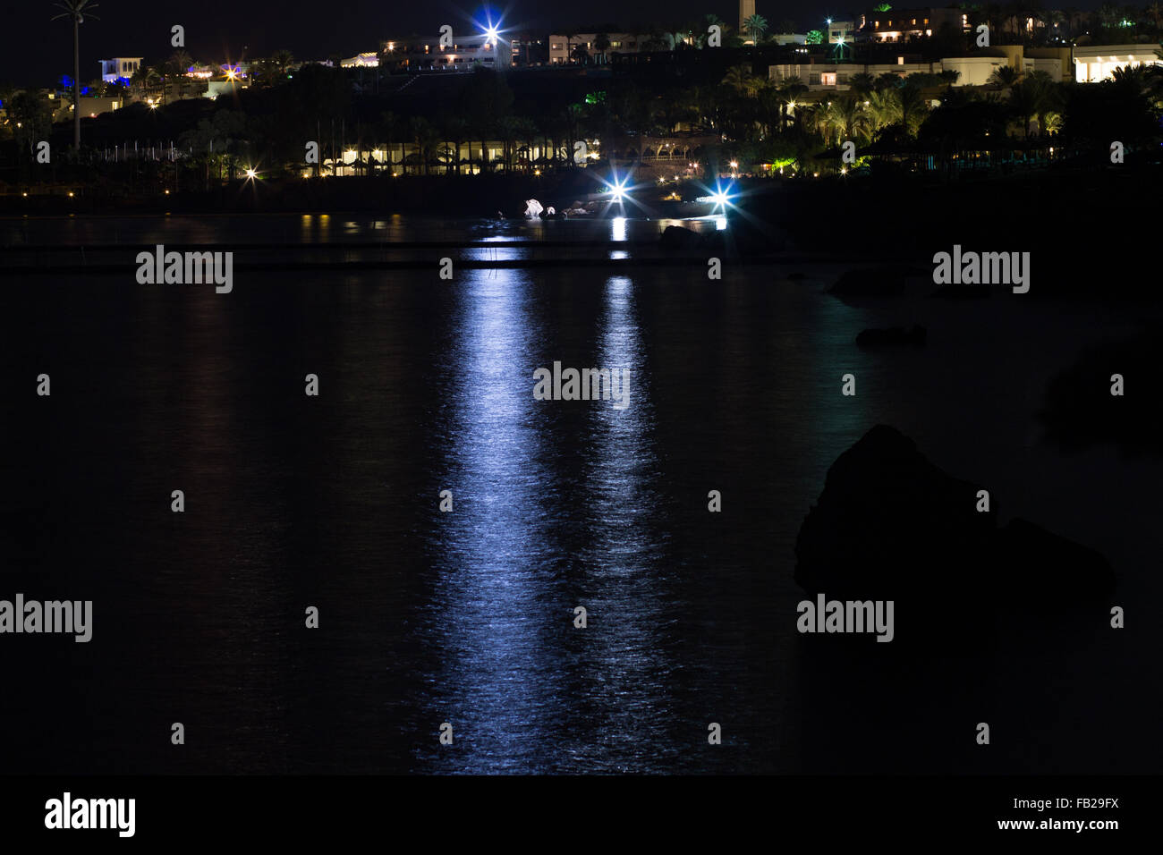Night view on resort town on the sea coast. Tropical vacation ...