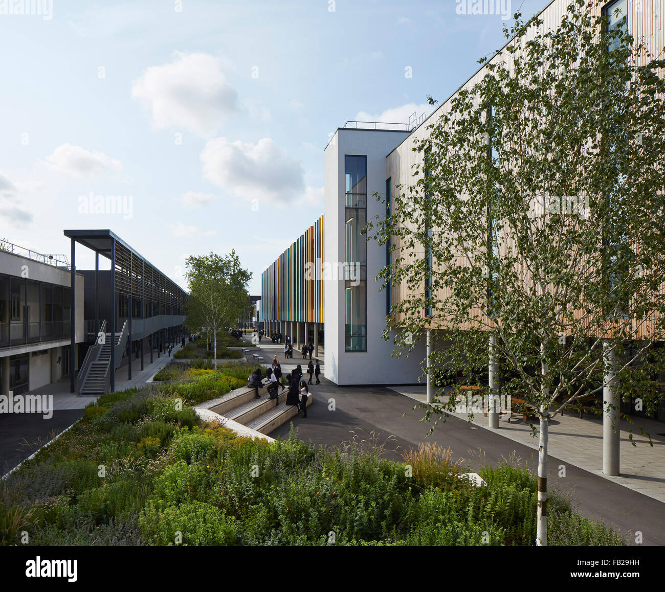Landscaped schoolyard with students. Regent High School, London, United ...
