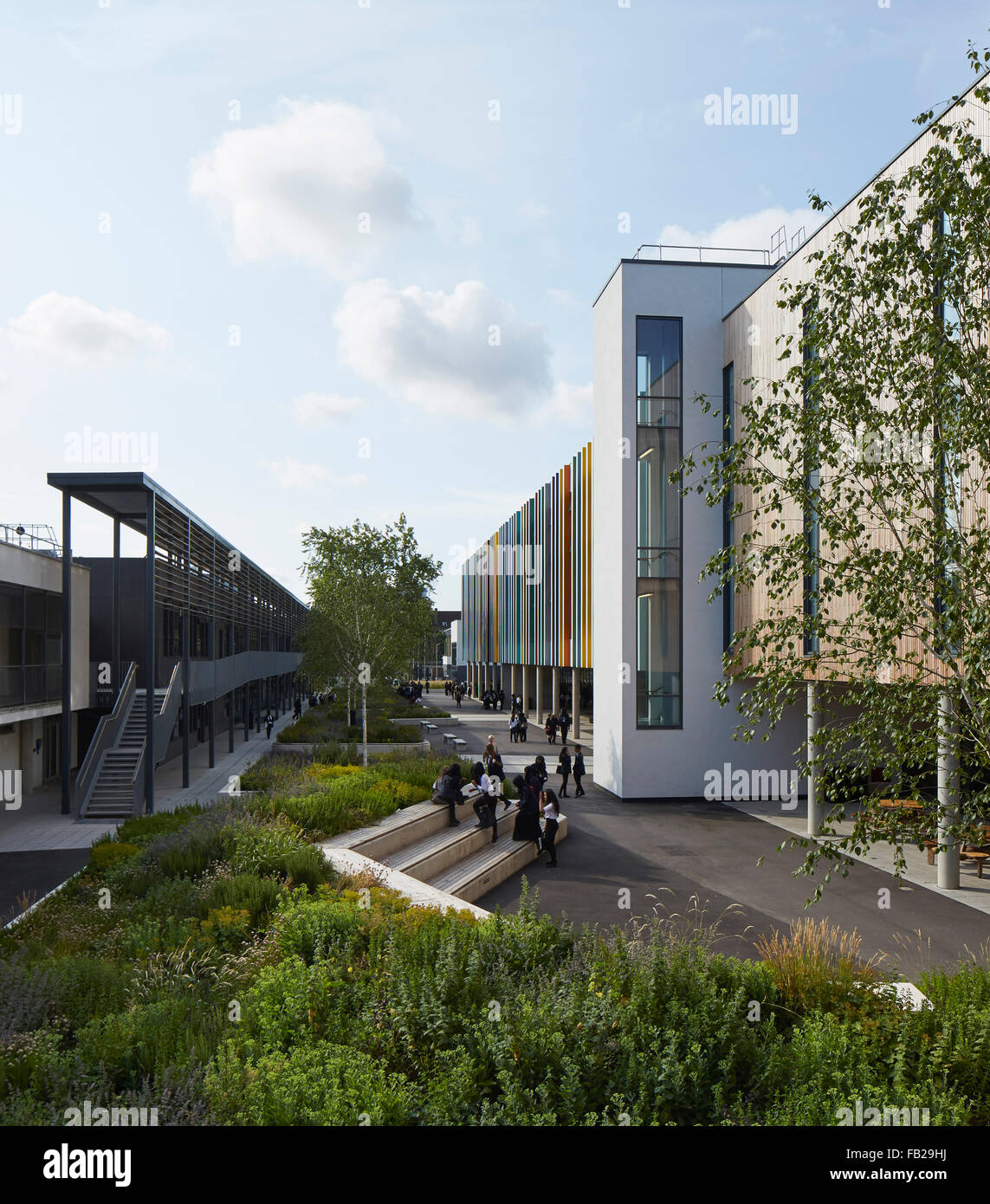 Landscaped schoolyard with students. Regent High School, London, United ...