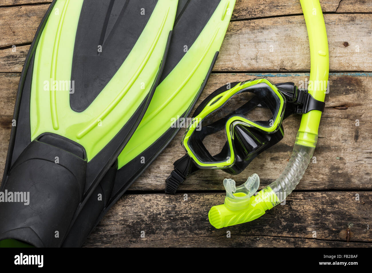 Snorkelling equipment on wood background. Flippers, mask and snorkel ...