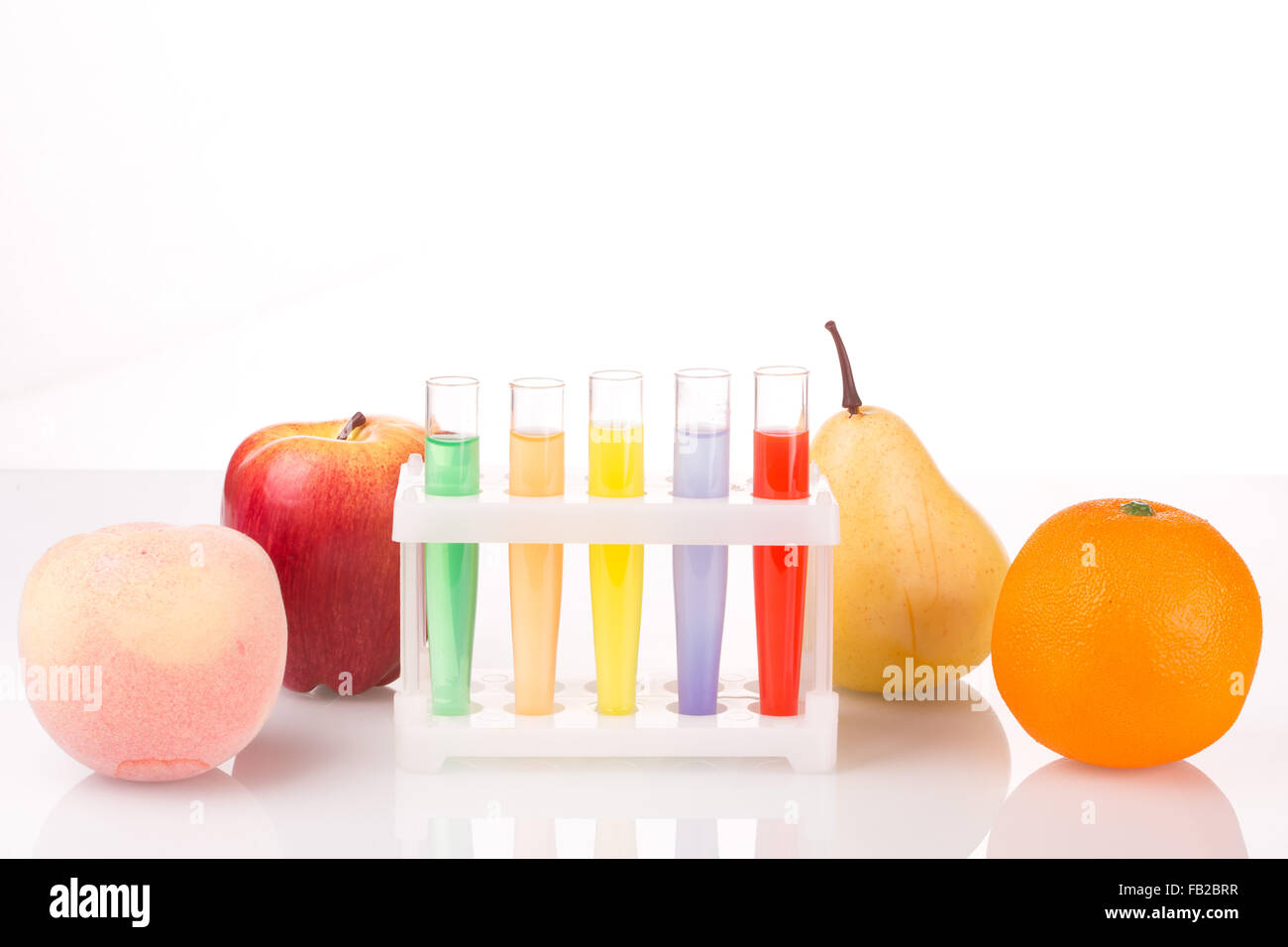 Fruit close chemical test tubes. Genetic Engineering. pesticides in ...