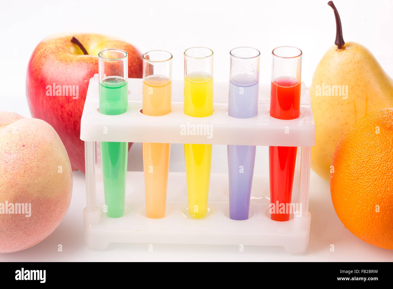 Fruit close chemical test tubes. Genetic Engineering. pesticides in ...