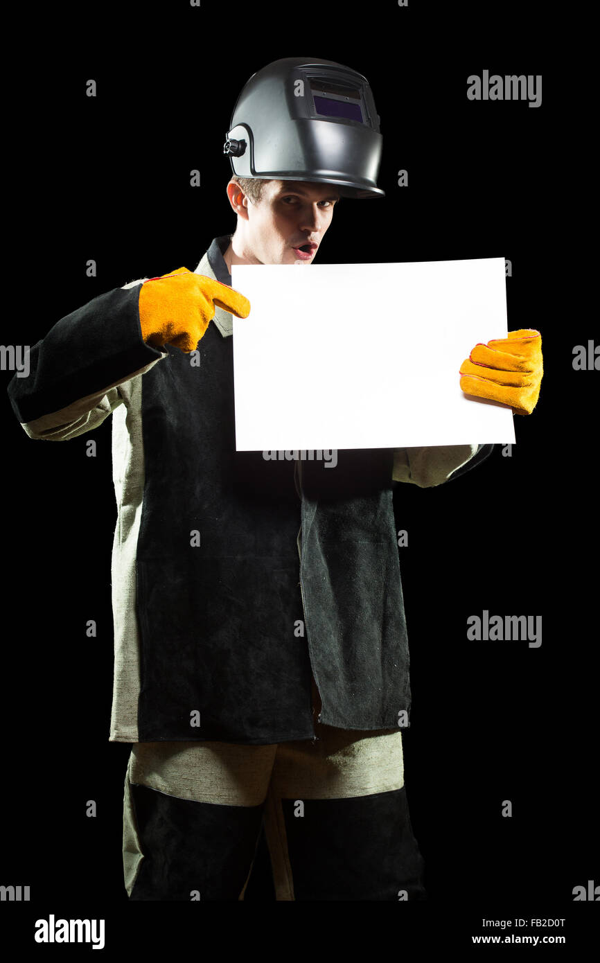 handsome welder holding a blank form. isolated on black background ...