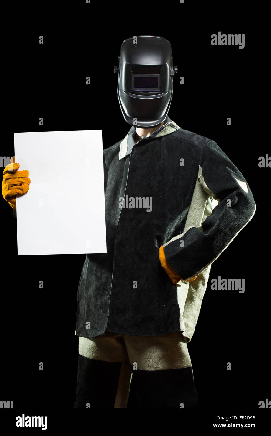 handsome welder holding a blank form. isolated on black background ...