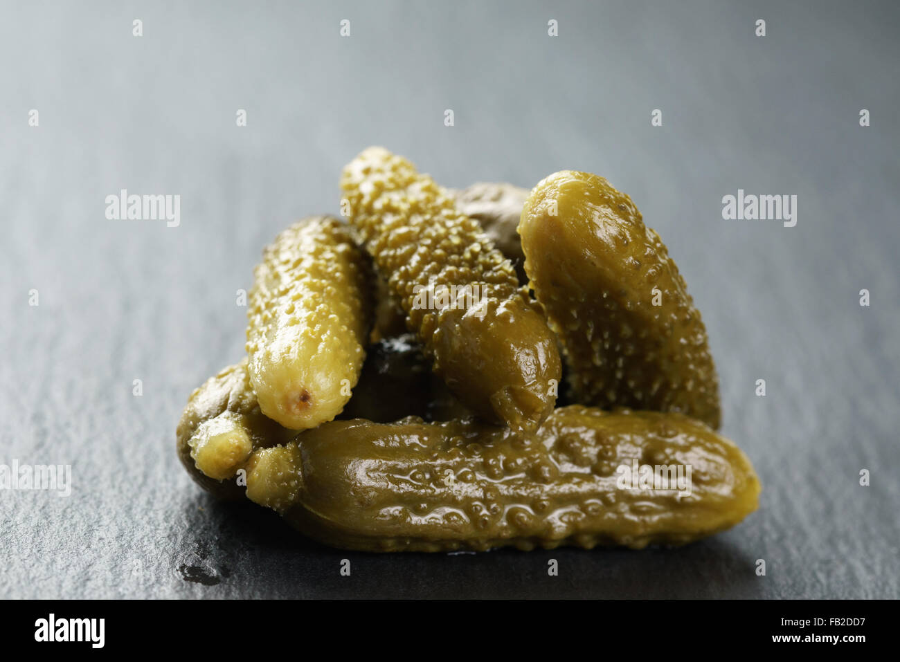 marinated cornichons on slate board Stock Photo - Alamy