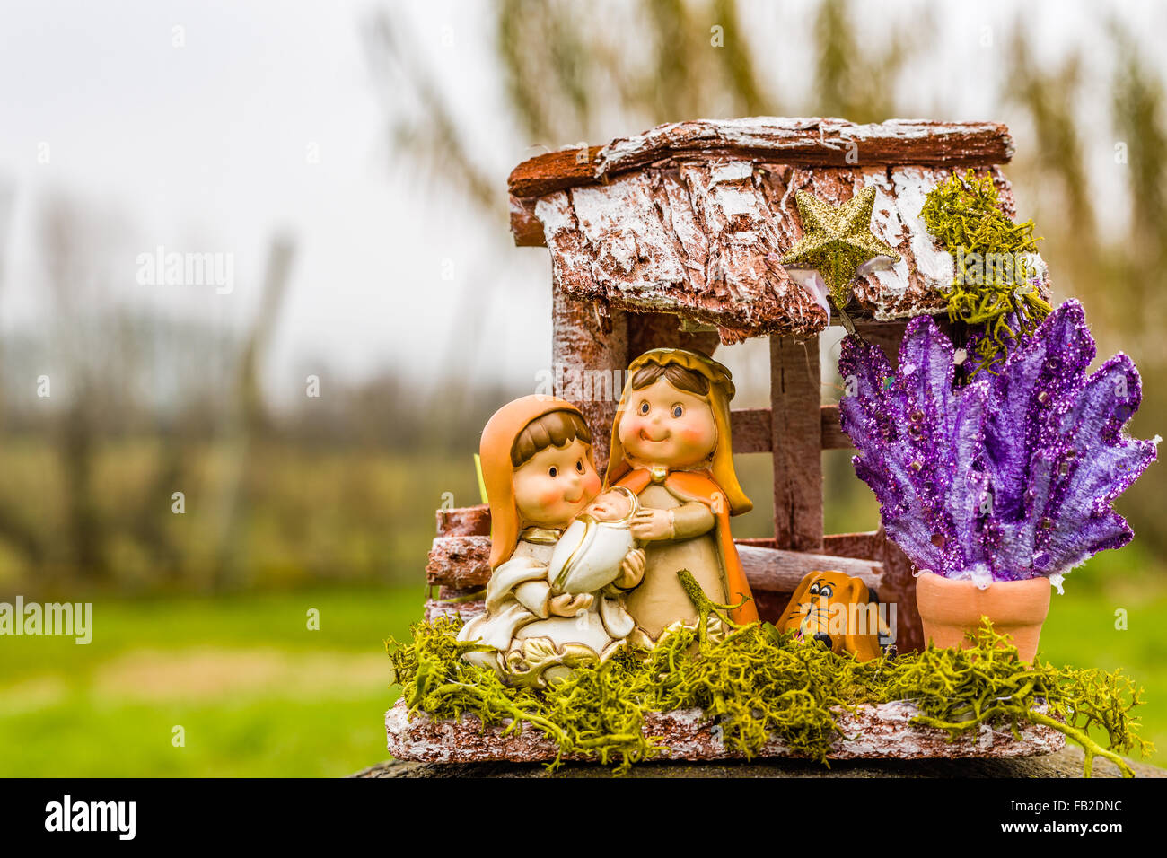 vivid colors of a Christmas Nativity scene, the Blessed Virgin Mary and Saint Joseph watch over ...