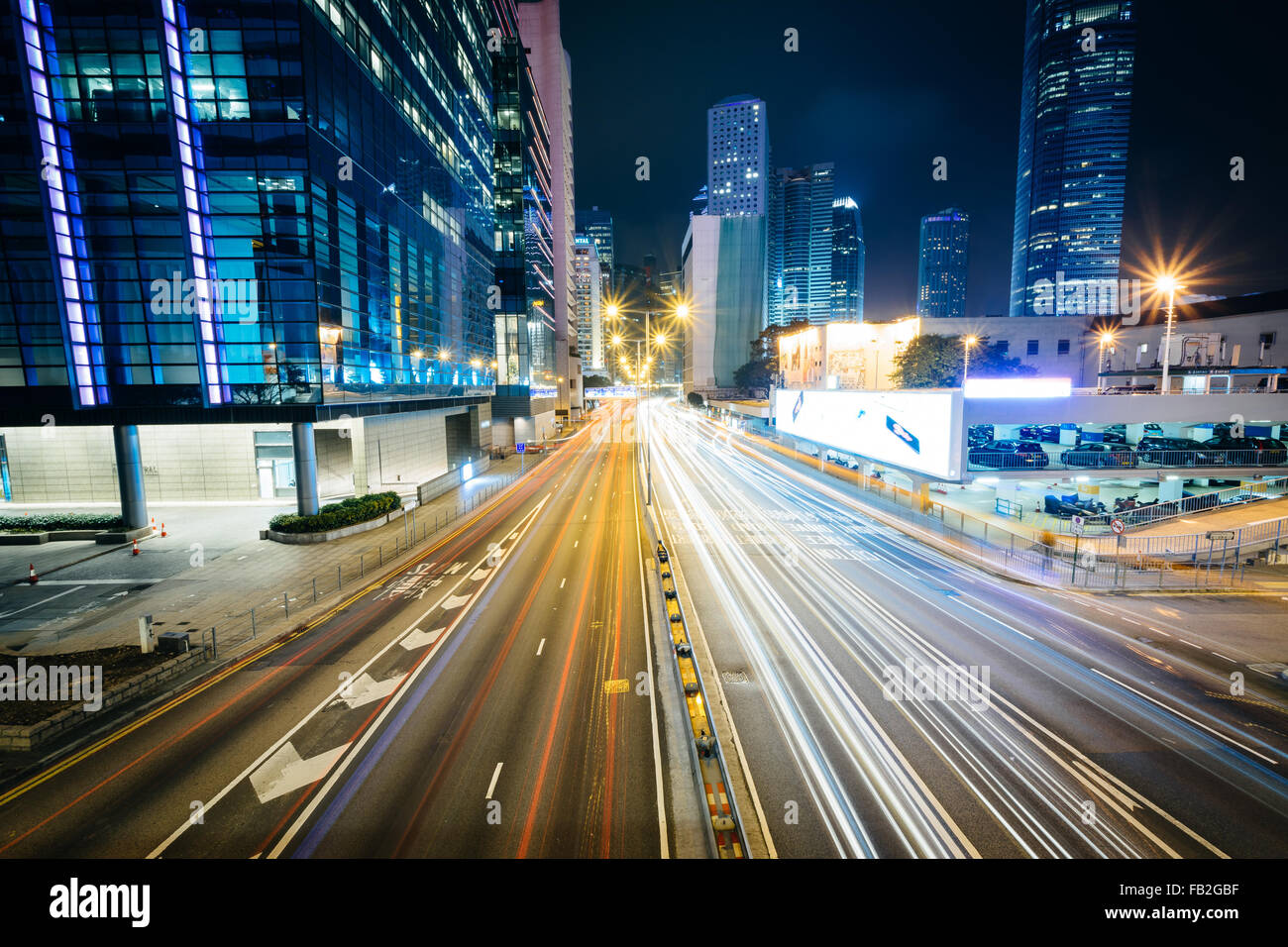 Long exposure of traffic on Connaught Road and skyscrapers at night, in ...