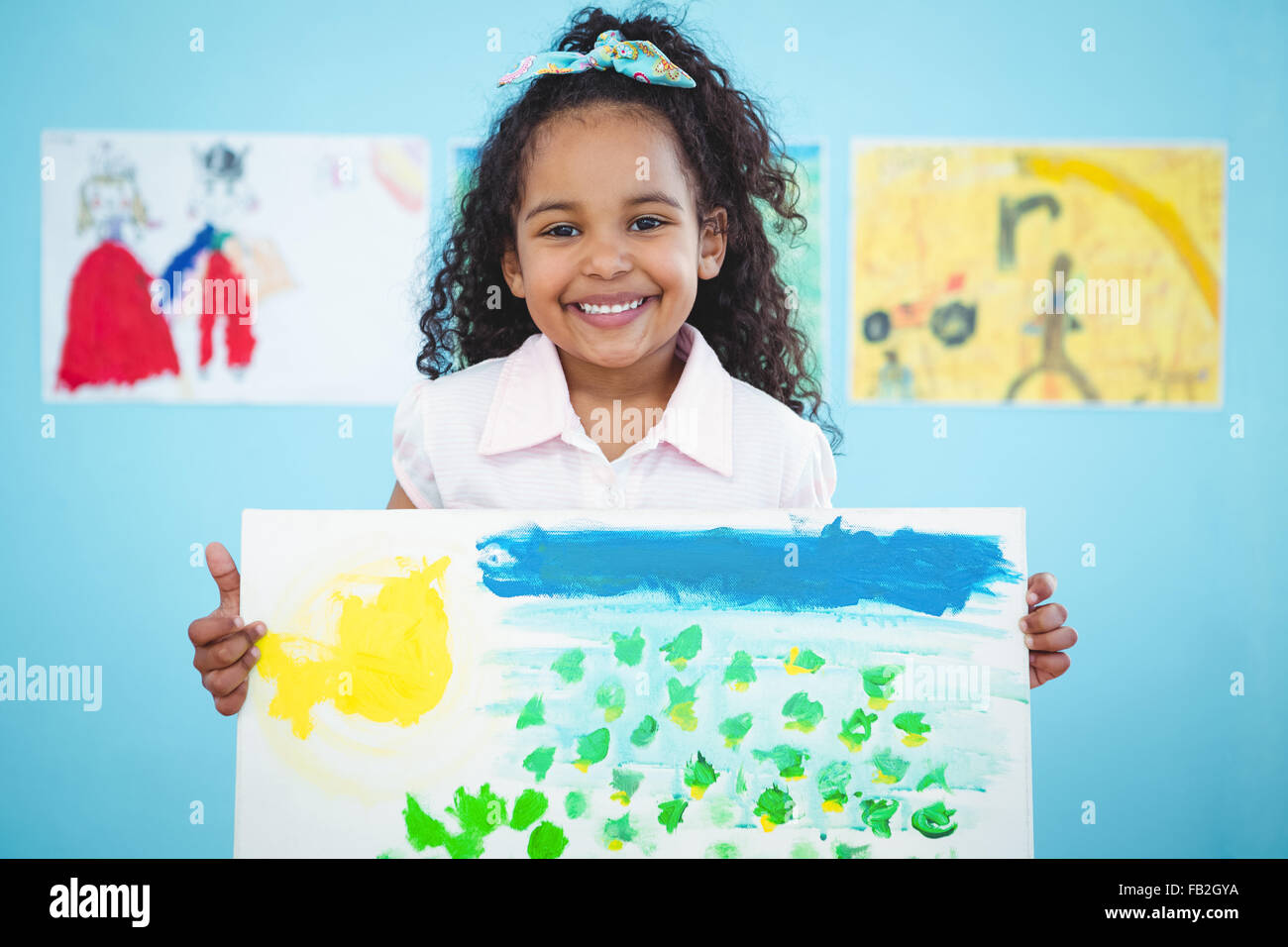 Cute girl showing her drawing Stock Photo - Alamy