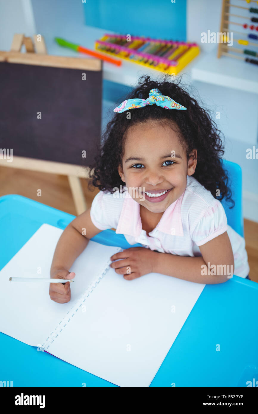 Cute girl sitting desk writing hi-res stock photography and images - Alamy
