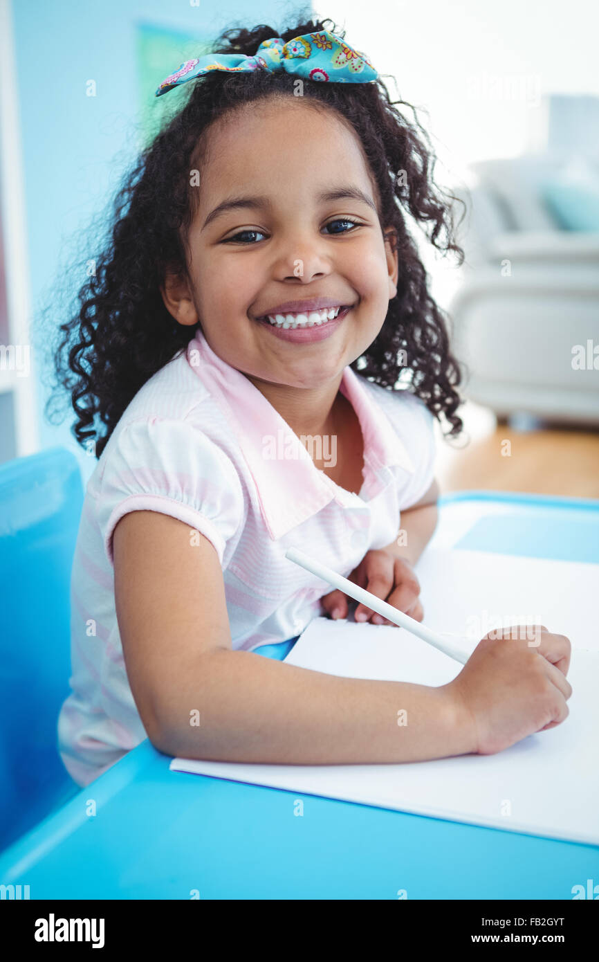 Cute girl writing on notebook Stock Photo - Alamy