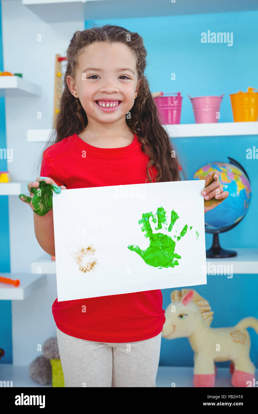 Cute girl showing paper with colored hands prints on it Stock Photo - Alamy